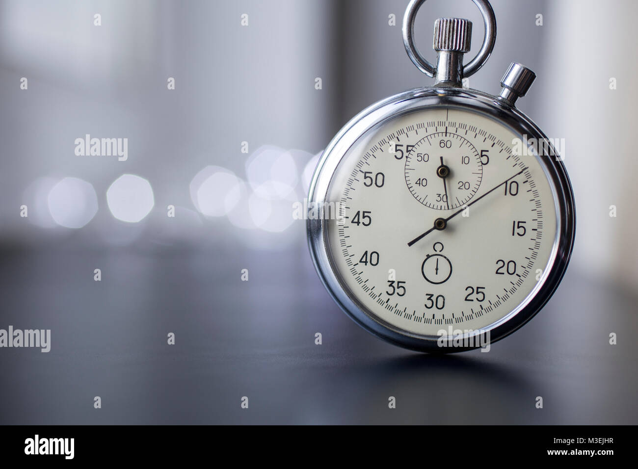 Clock on a blurry background with bokeh Stock Photo - Alamy
