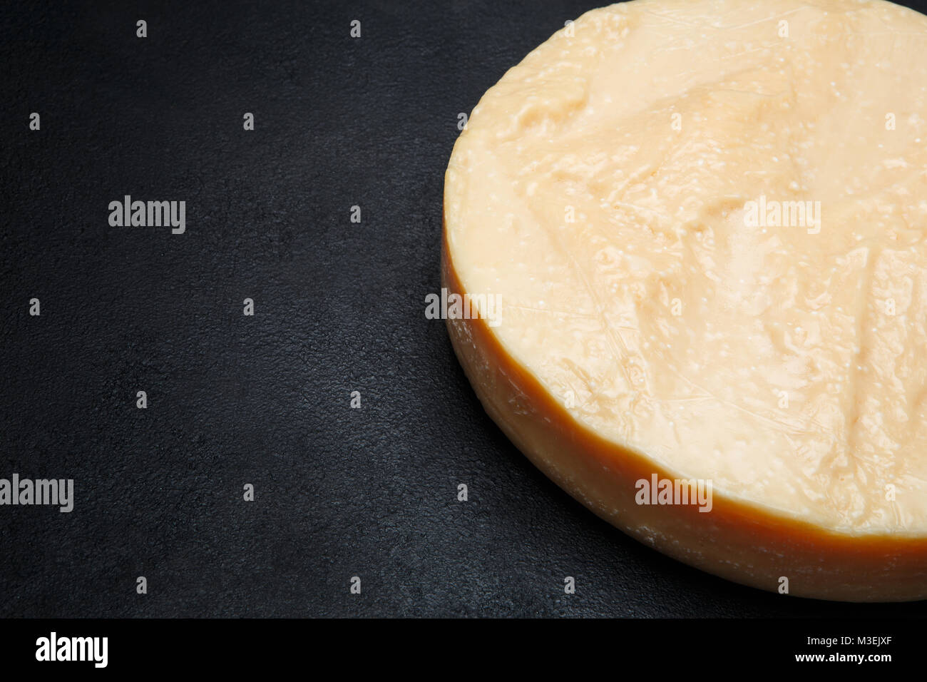Whole round Head of parmesan or parmigiano hard cheese on concrete ...