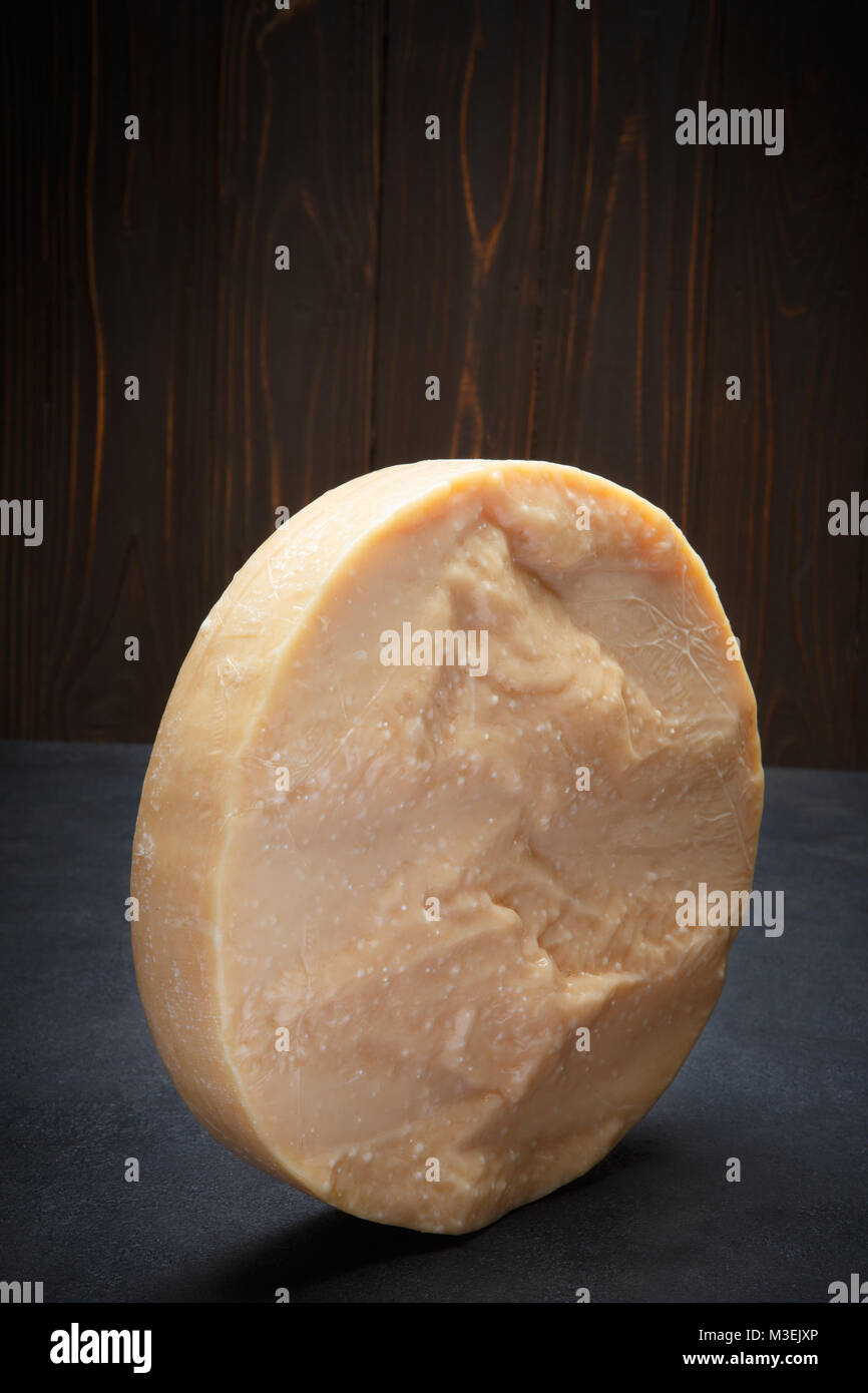 Whole round Head of parmesan or parmigiano hard cheese on concrete ...