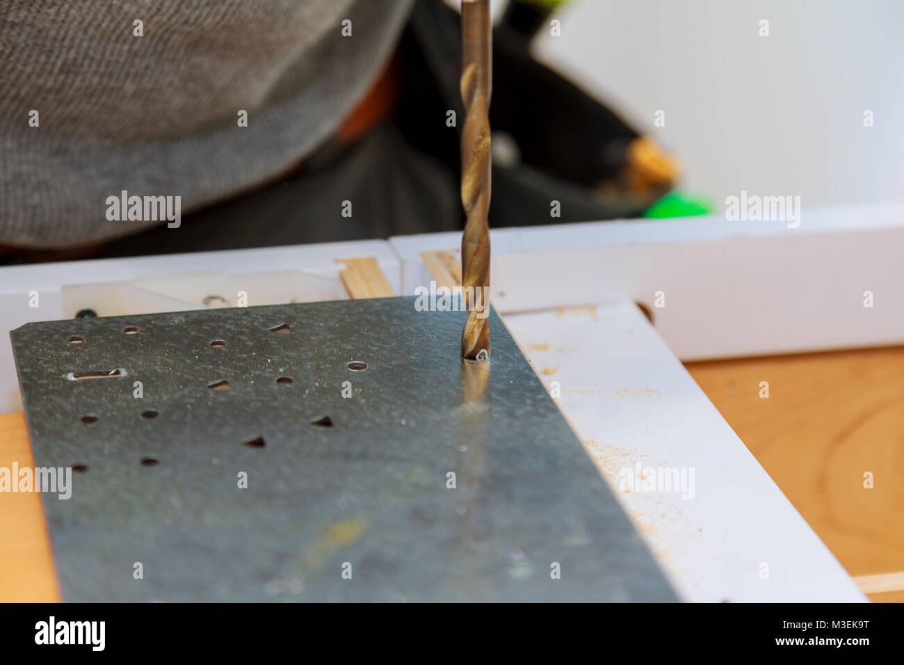 Drilling machine working on flat steel plate, hole is drilled, strongly ...