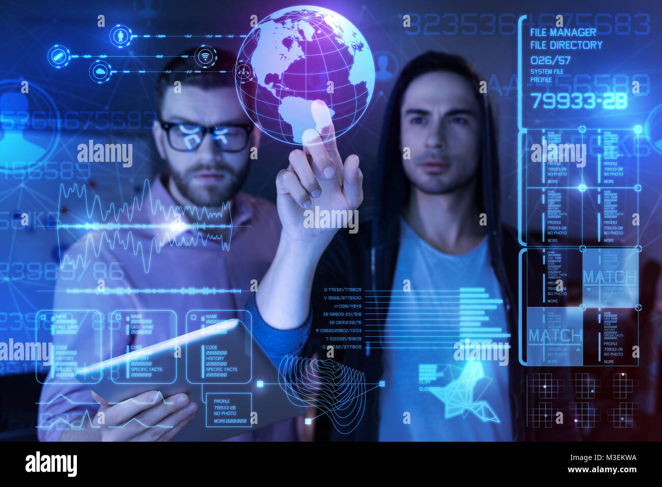 Concentrated programmer touching the virtual earth Stock Photo - Alamy Concentrated programmer touching the virtual earth Stock Photo - Alamy