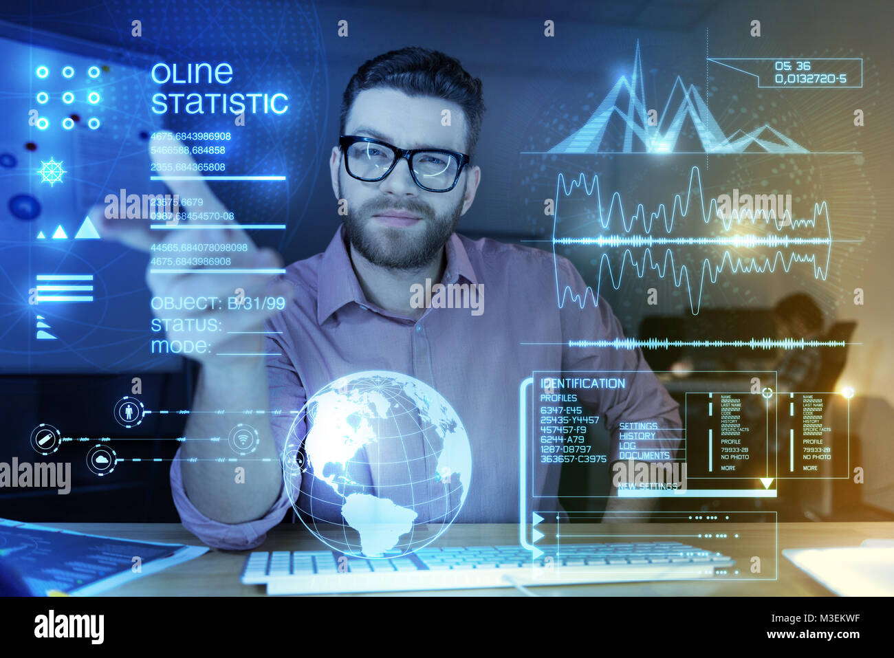 Young smart programmer pointing to the transparent screen and looking ...