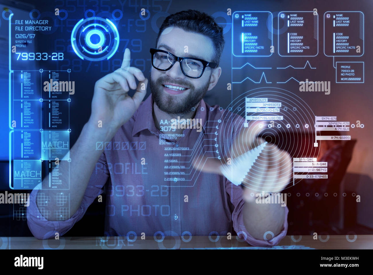 Positive programmer sitting with his finger up and smiling Stock Photo ...