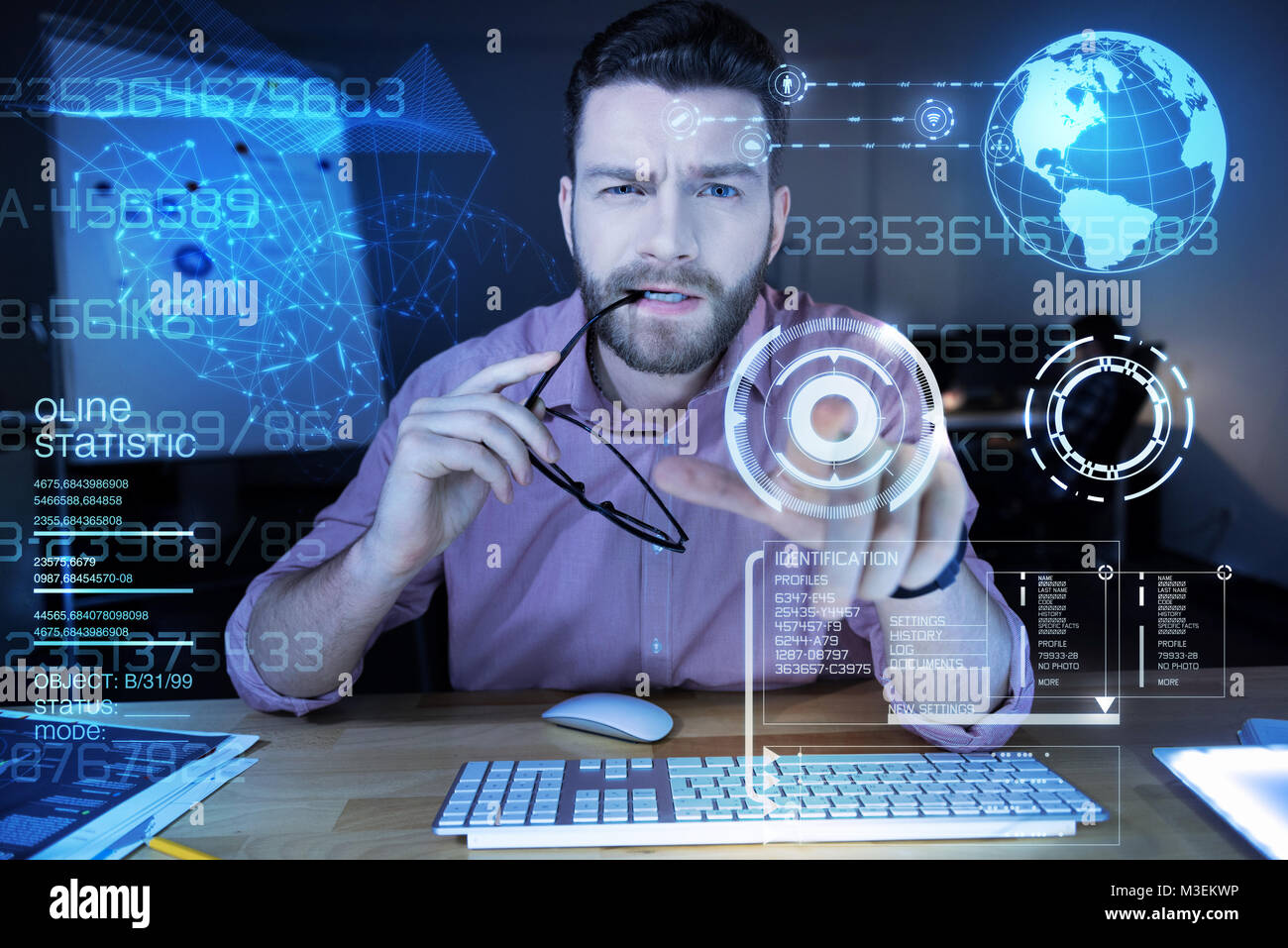 Smart programmer frowning while biting his glasses and pointing to the ...