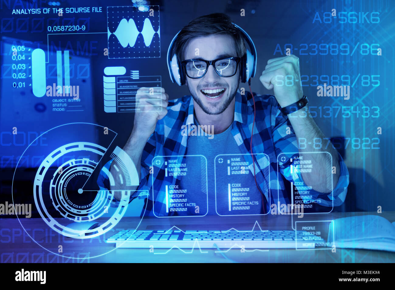 Cheerful young man looking happy while being at work Stock Photo - Alamy