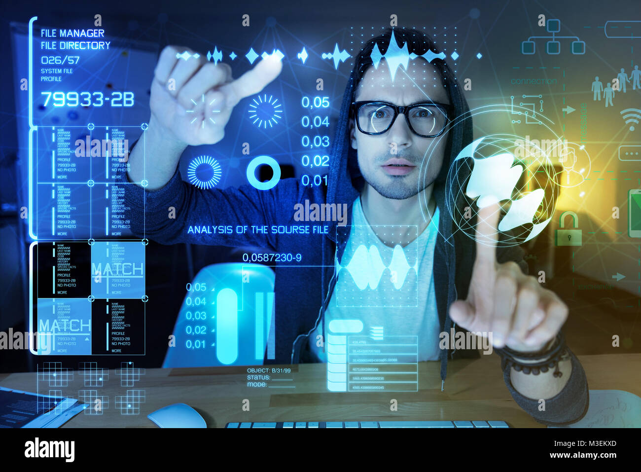 Smart programmer touching two virtual schemes and looking serious Stock ... Smart programmer touching two virtual schemes and looking serious Stock ...