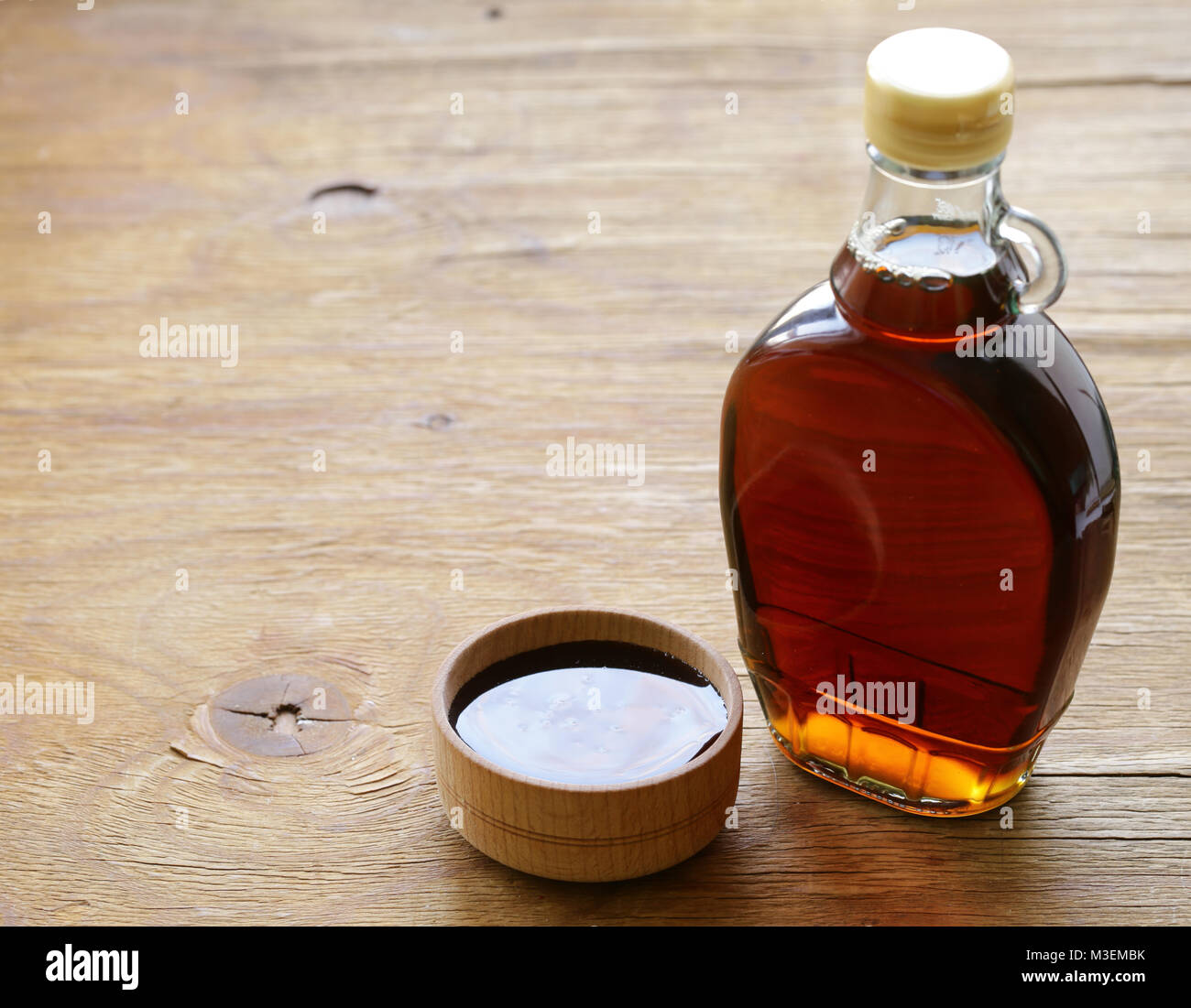 Maple syrup in a glass bottle - sweet dessert sauce Stock Photo - Alamy
