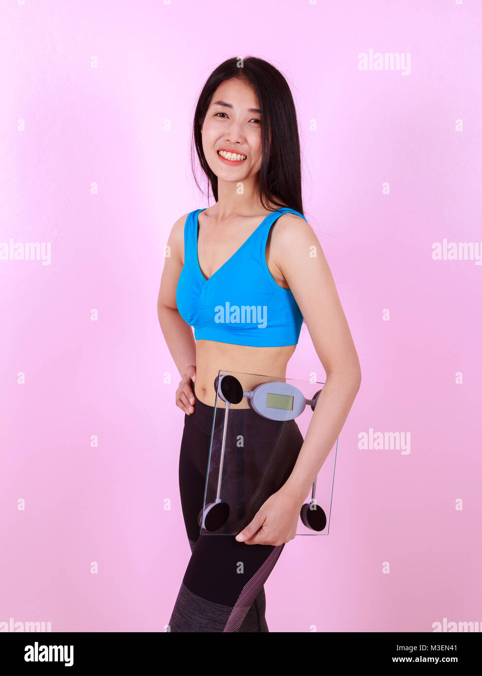 happy slim woman holding a weight scale Stock Photo - Alamy