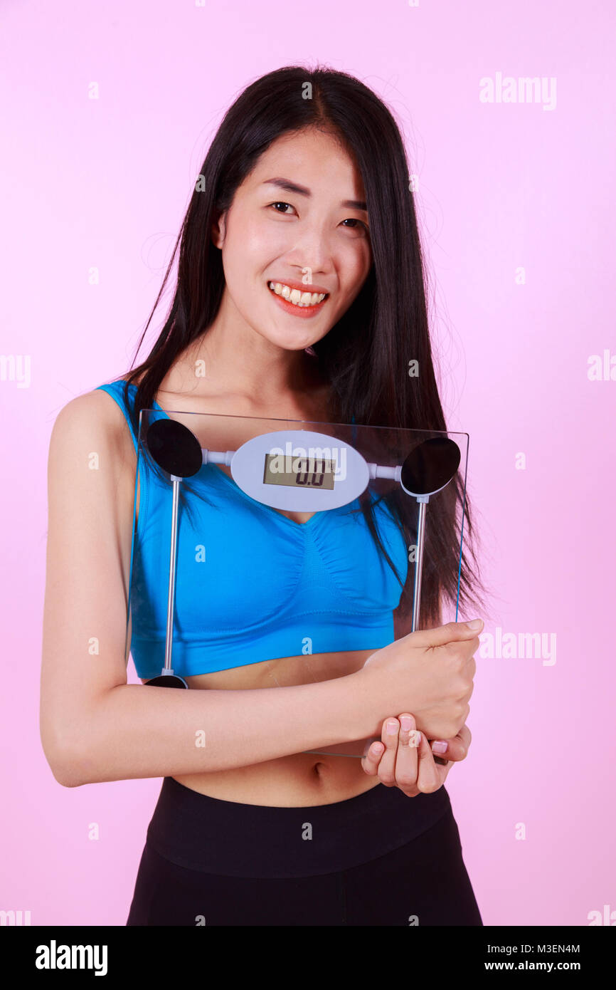 happy slim woman holding a weight scale Stock Photo - Alamy
