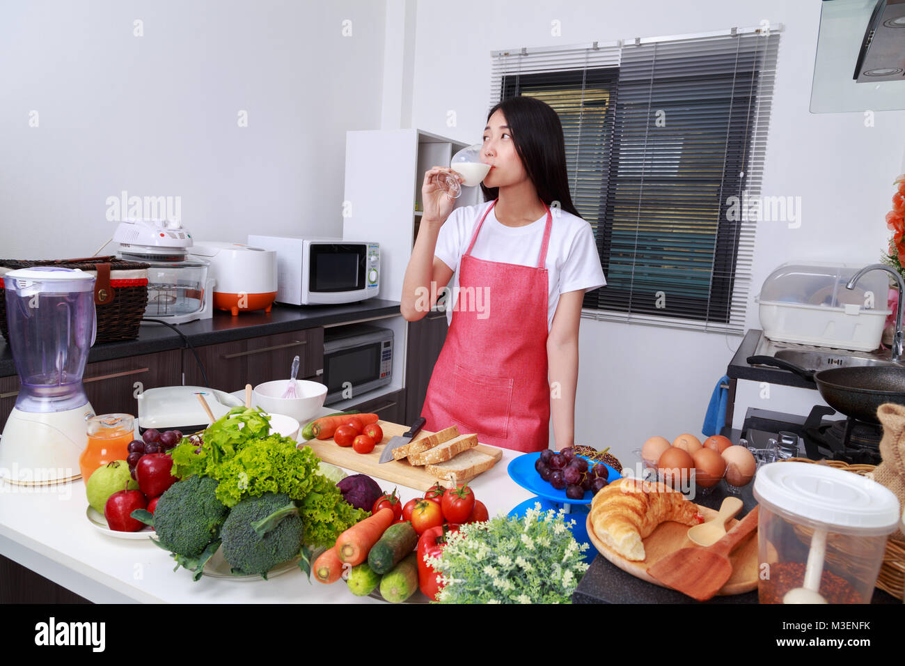 woman drinking milk in kitchen room at home Stock Photo - Alamy