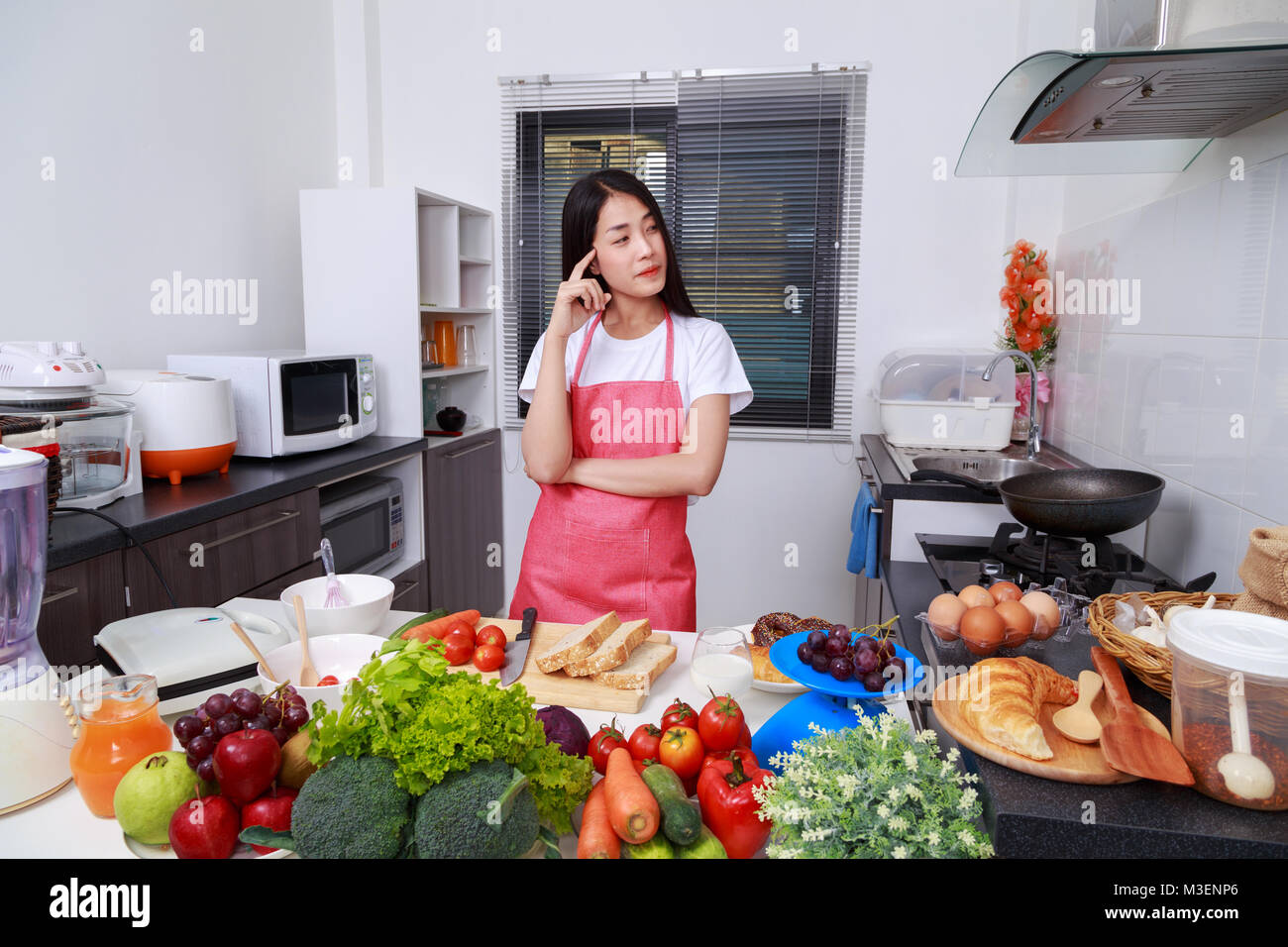 woman thinking about cooking in kitchen room at home Stock Photo - Alamy