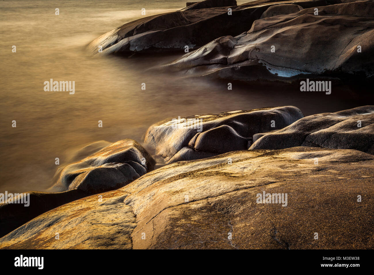 Golden hour on rocks, taken in Pori, Finland Stock Photo - Alamy
