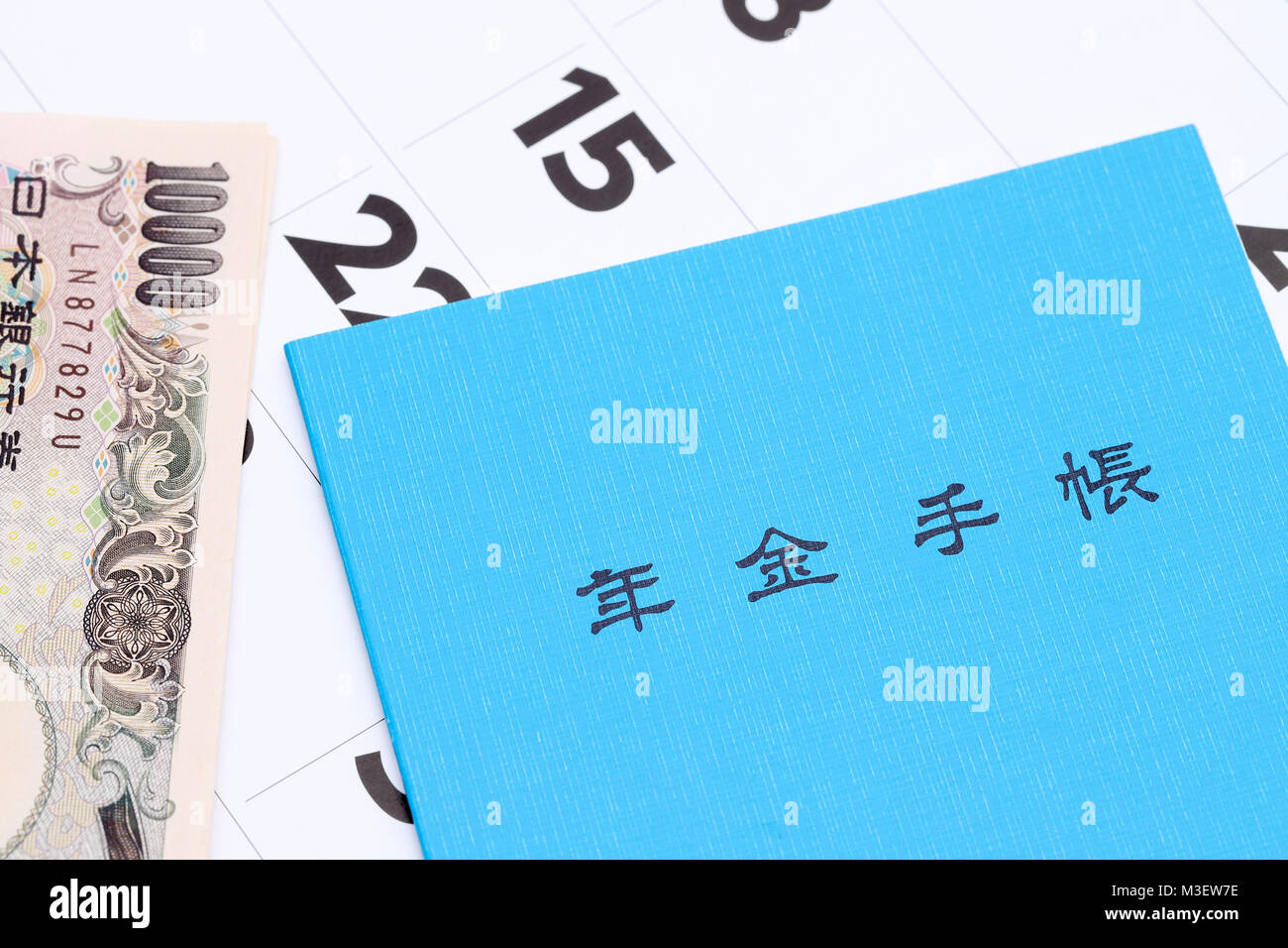 Japanese national pension plan handbook and money on calendar ...