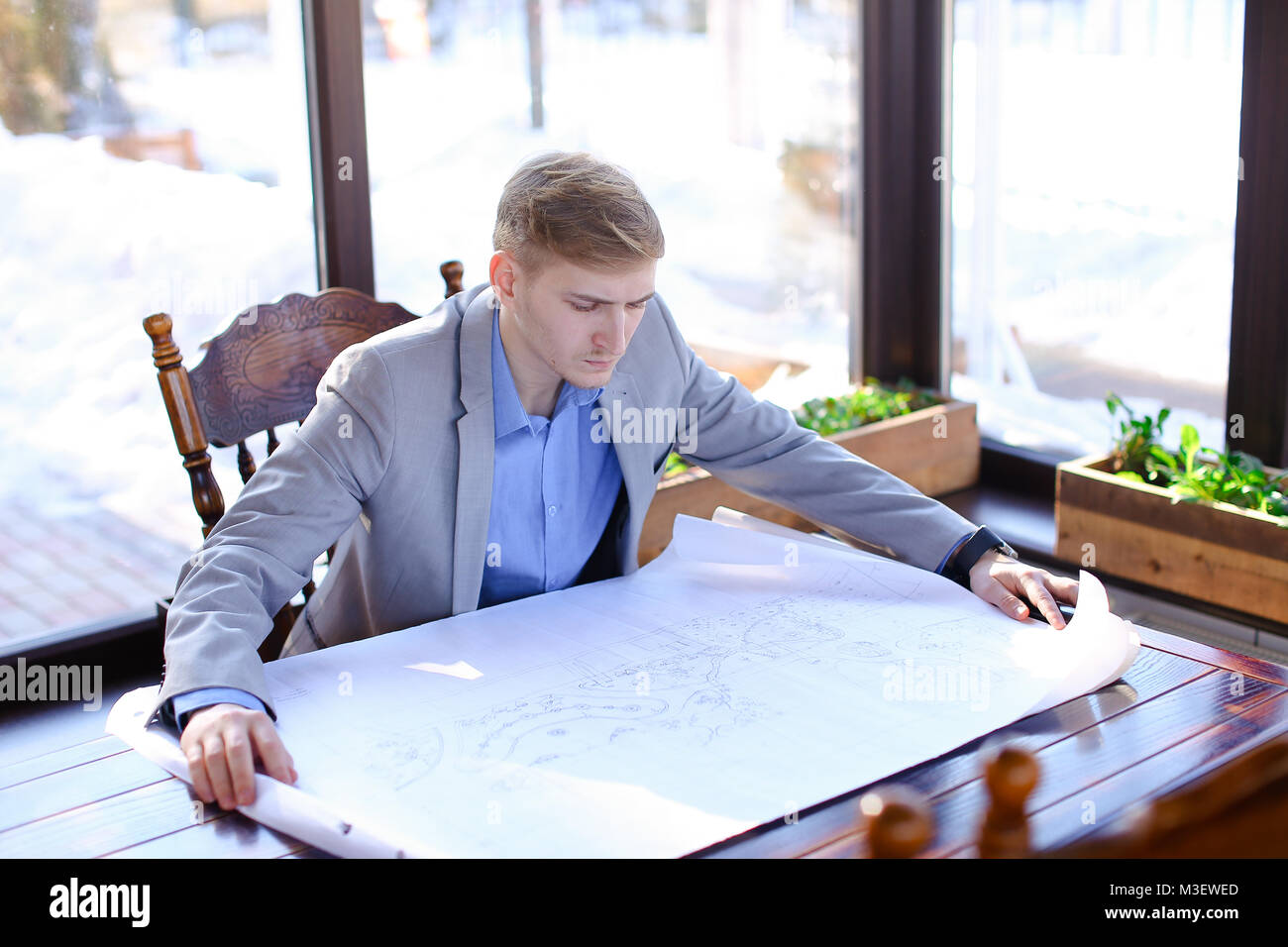 Architect waiting for customer at cafe with roll architecture pr Stock ...