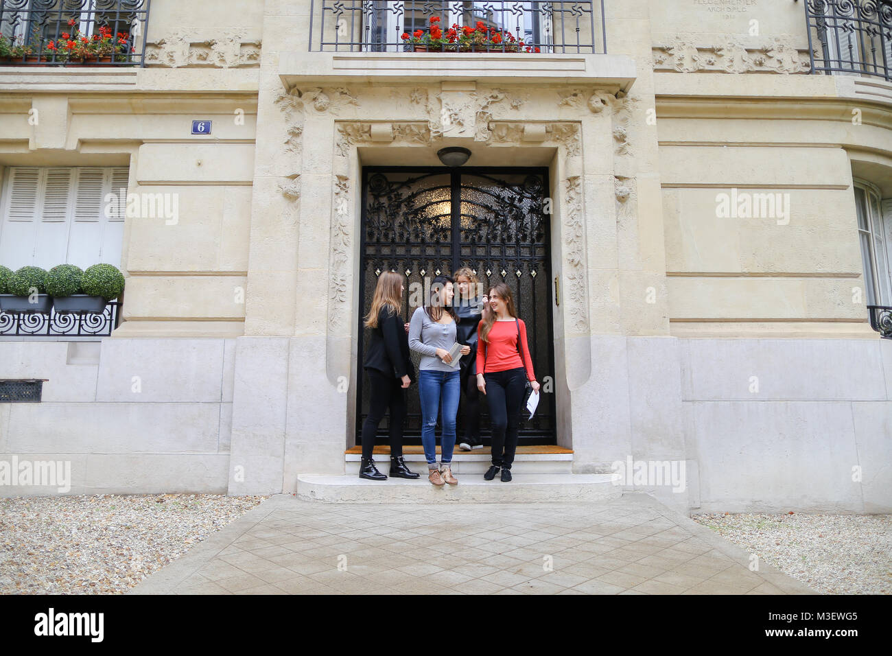 Happy students leaving university building in Stock Photo - Alamy