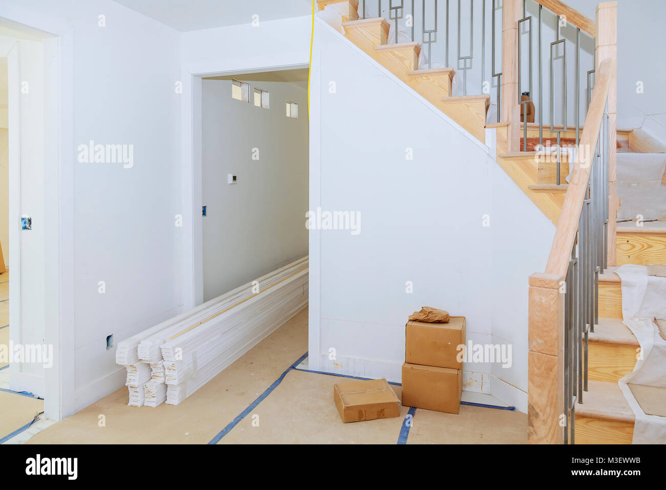 Brand new house construction interior room with unfinished wood floors ...