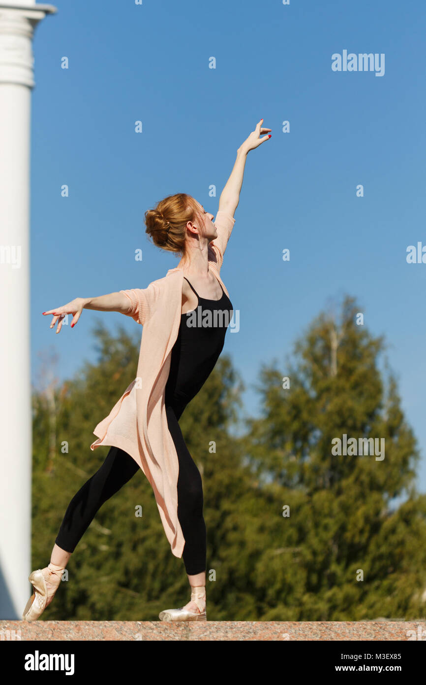 Young graceful ballerina dancing at the building. Beauty and grace of ...