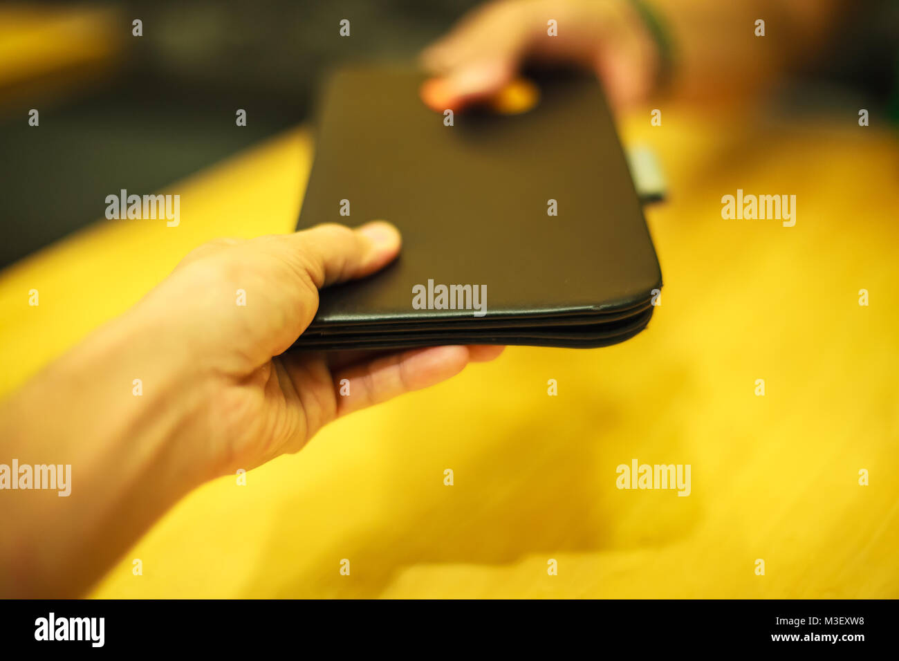 selective focus customer hand receive bill payment receipt in black ...