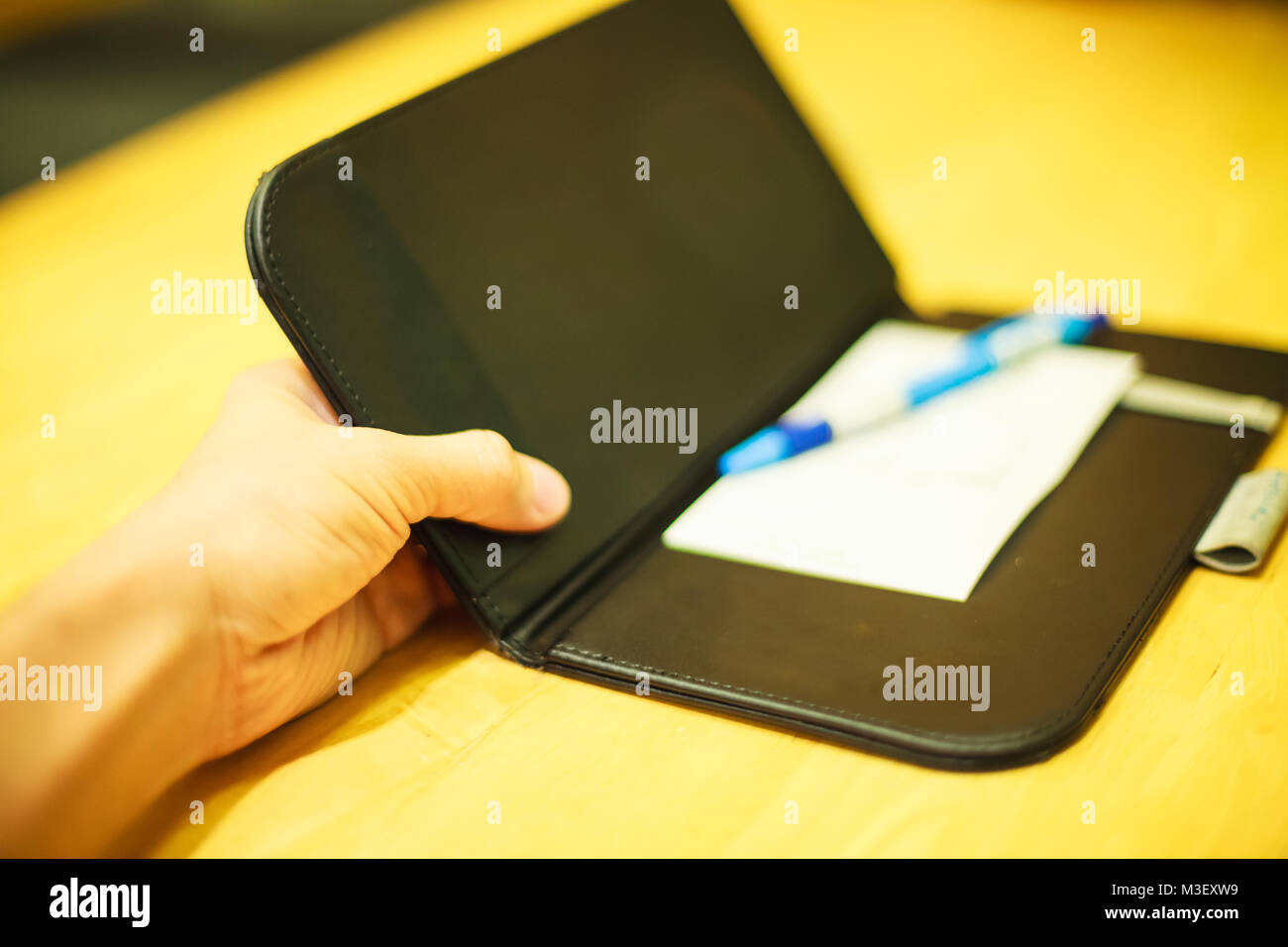 selective focus customer hand receive bill payment receipt in black ...