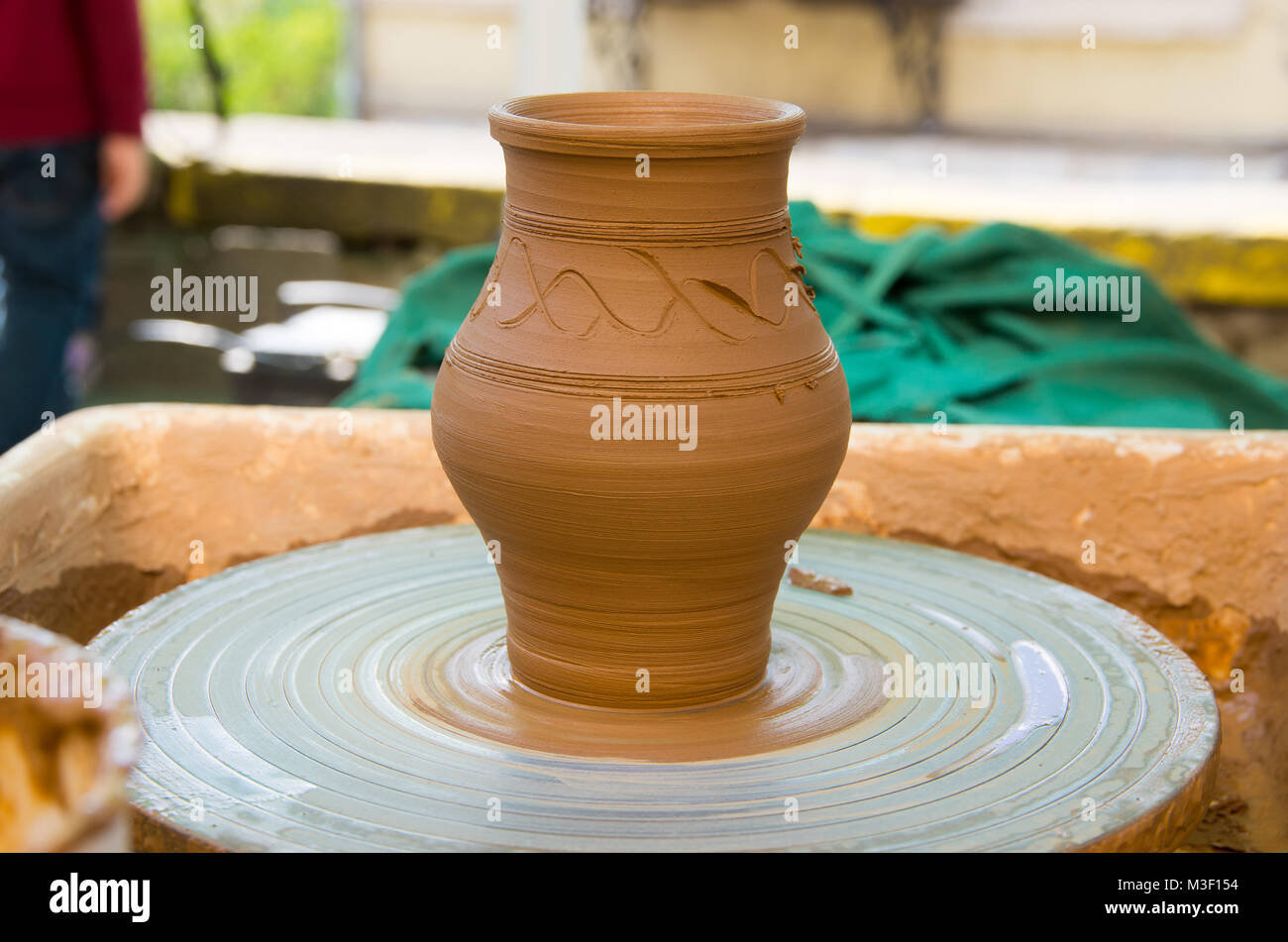 Clay pot on a pottery wheel Stock Photo - Alamy