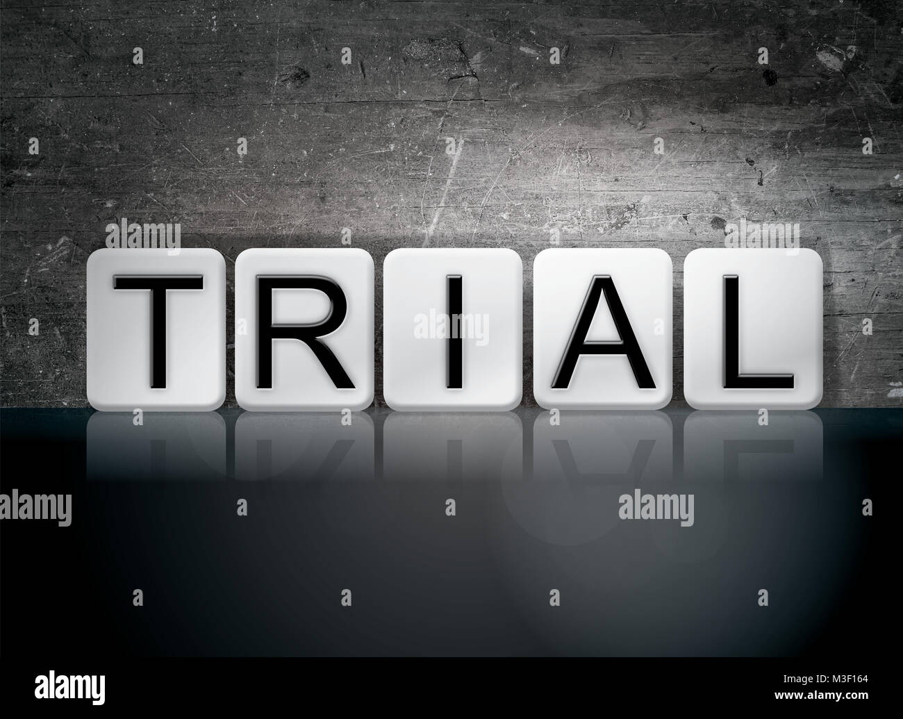 The word Trial concept and theme written in white tiles on a dark ...