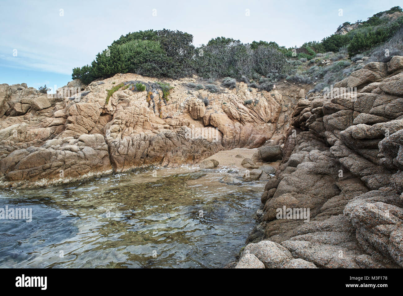 Climbing the distinctive rocks along the coastline of Sardinia Stock ...