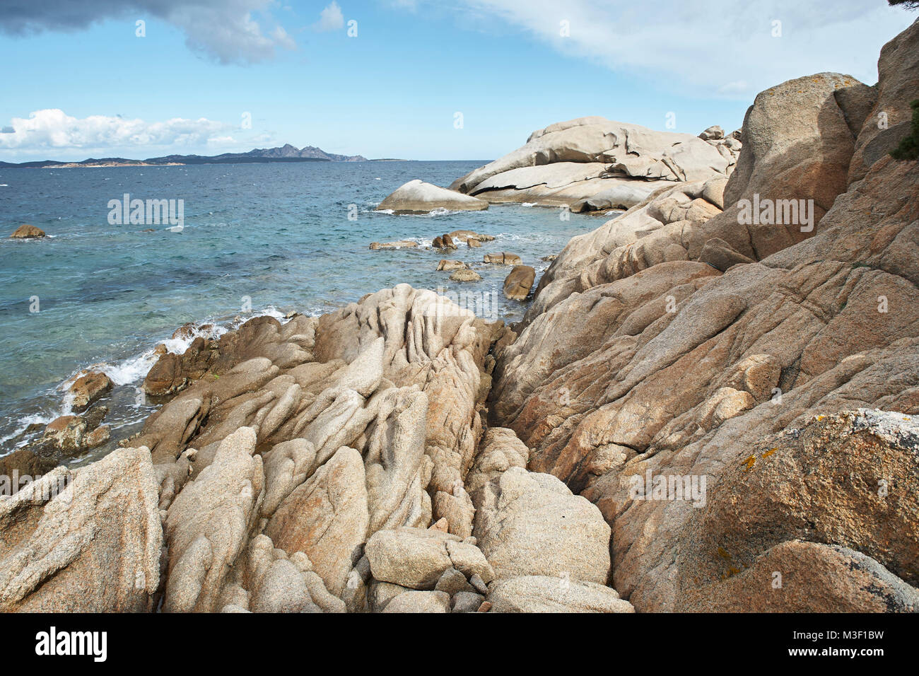 Climbing the distinctive rocks along the coastline of Sardinia Stock ...