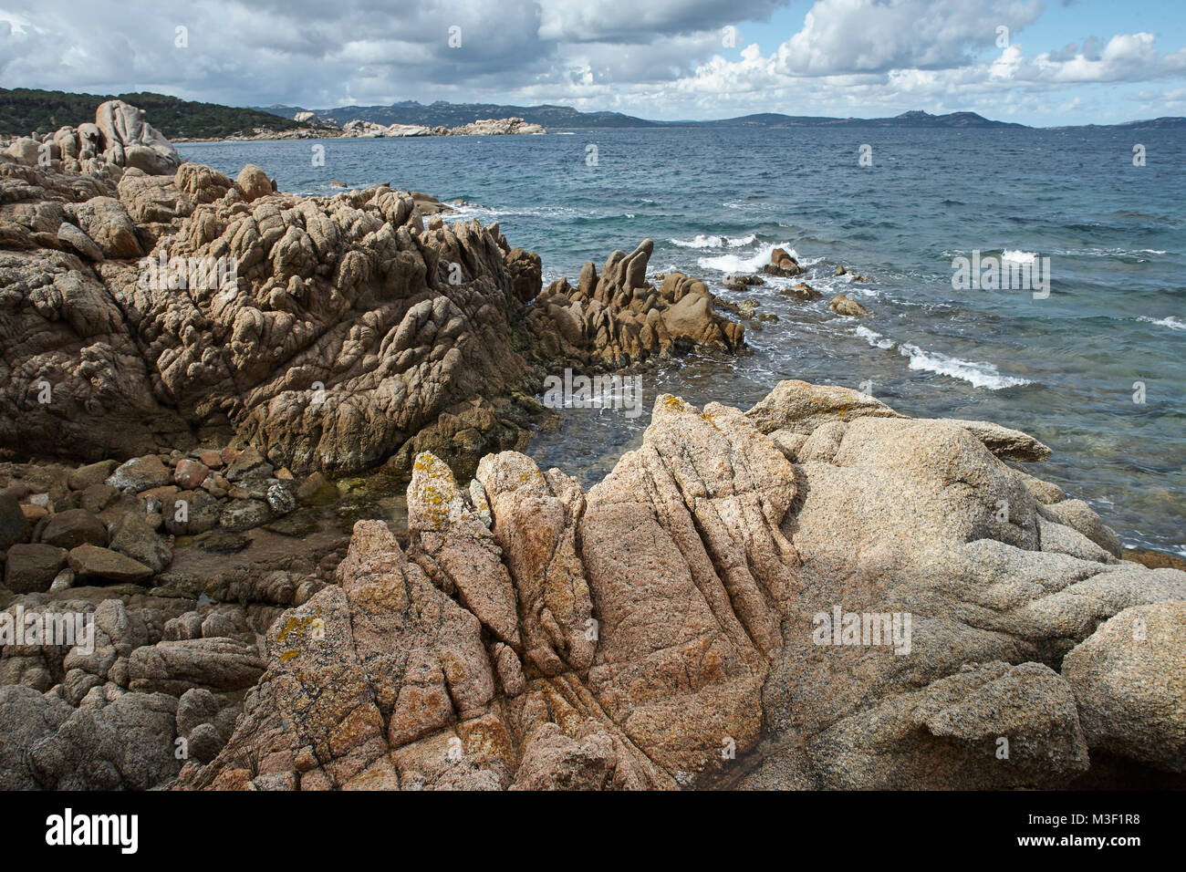 Climbing the distinctive rocks along the coastline of Sardinia Stock ...