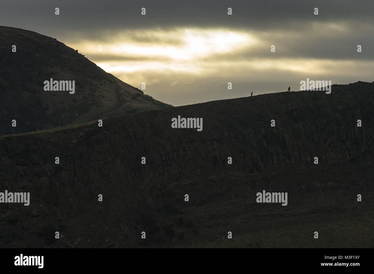 An overcast sunrise over Arthur's Seat and the Salisbury Craigs in ...