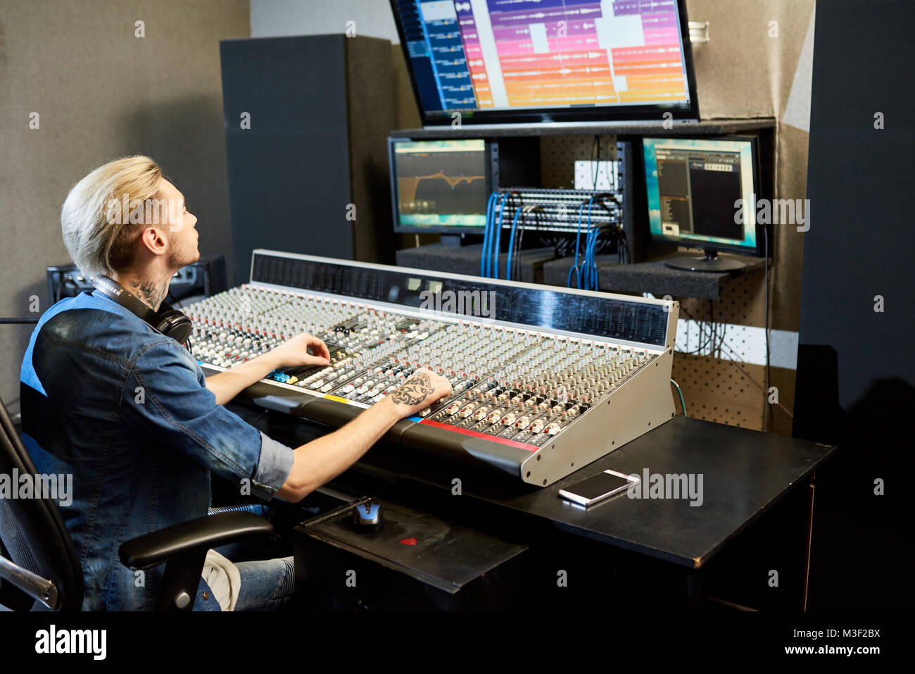 Male sound engineer editing soundtracks Stock Photo - Alamy