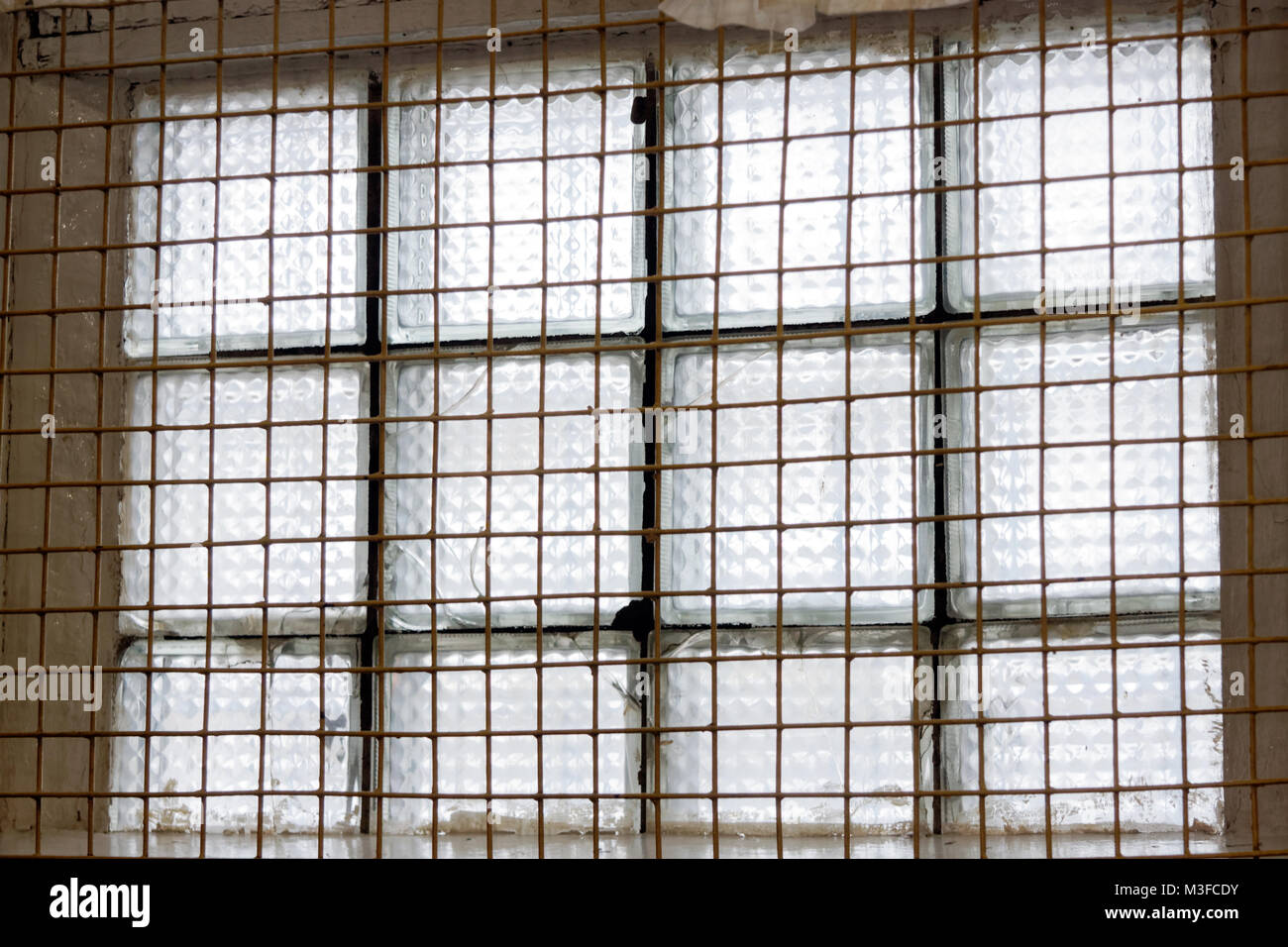 A look at the window of the prison cell from the inside. Metal lattice ...
