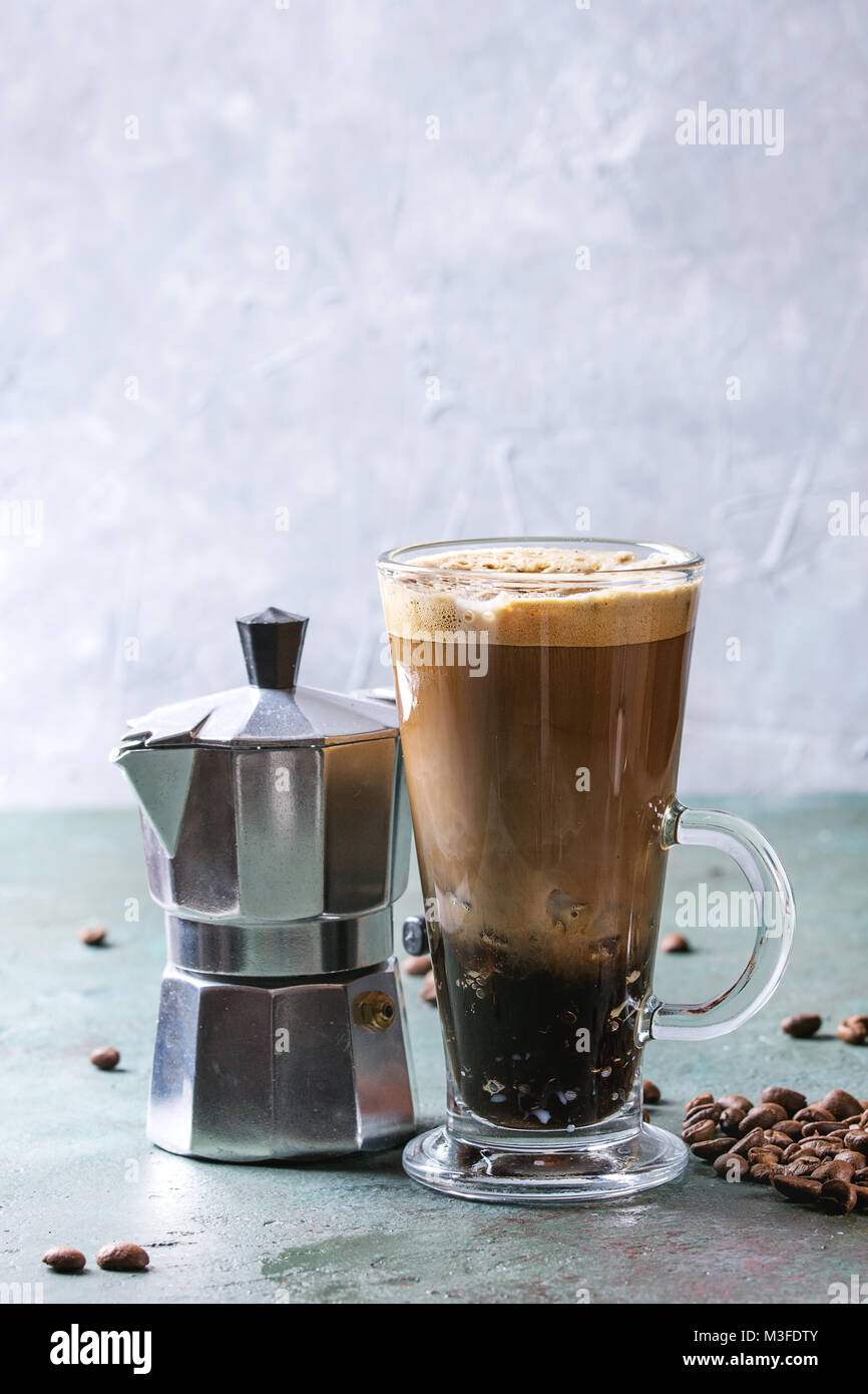 Fizzy iced Coffee espresso with milk, coffee maker and roasted beans ...