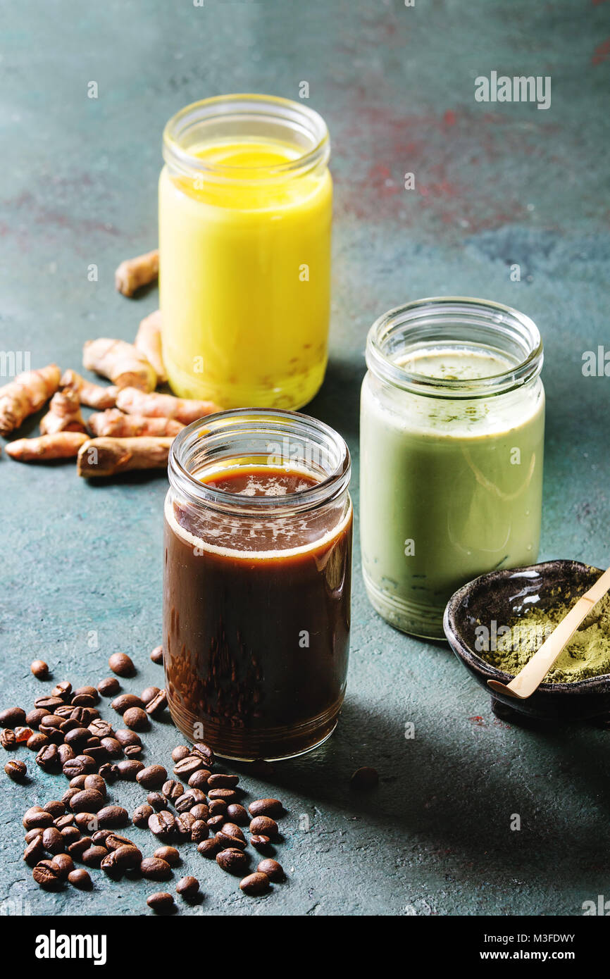 Variety of iced colorful latte drinks. Iced coffee, turmeric and matcha ...