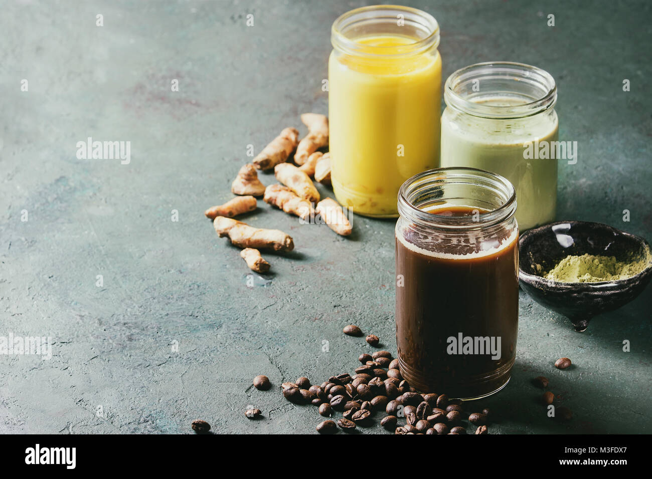 Variety of iced colorful latte drinks. Iced coffee, turmeric and matcha ...