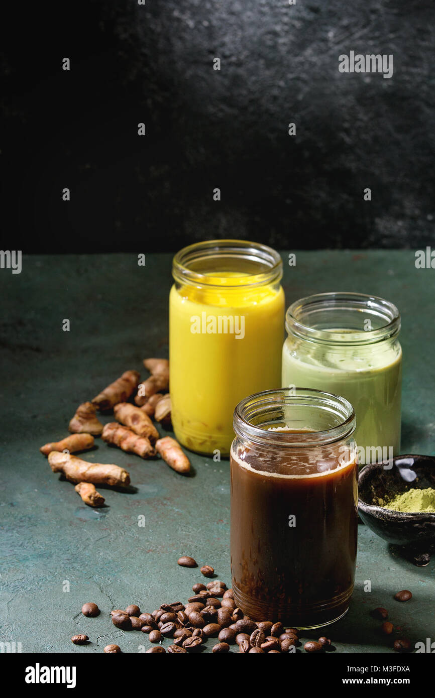 Variety of iced colorful latte drinks. Iced coffee, turmeric and matcha ...