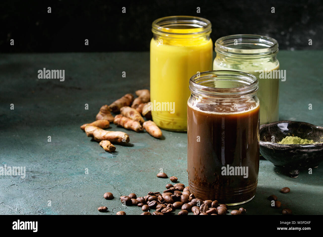 Variety of iced colorful latte drinks. Iced coffee, turmeric and matcha ...