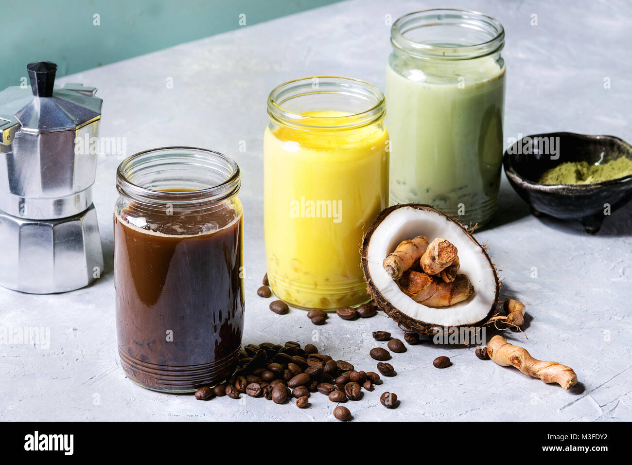 Variety of iced colorful latte drinks. Iced coffee, turmeric and matcha ...