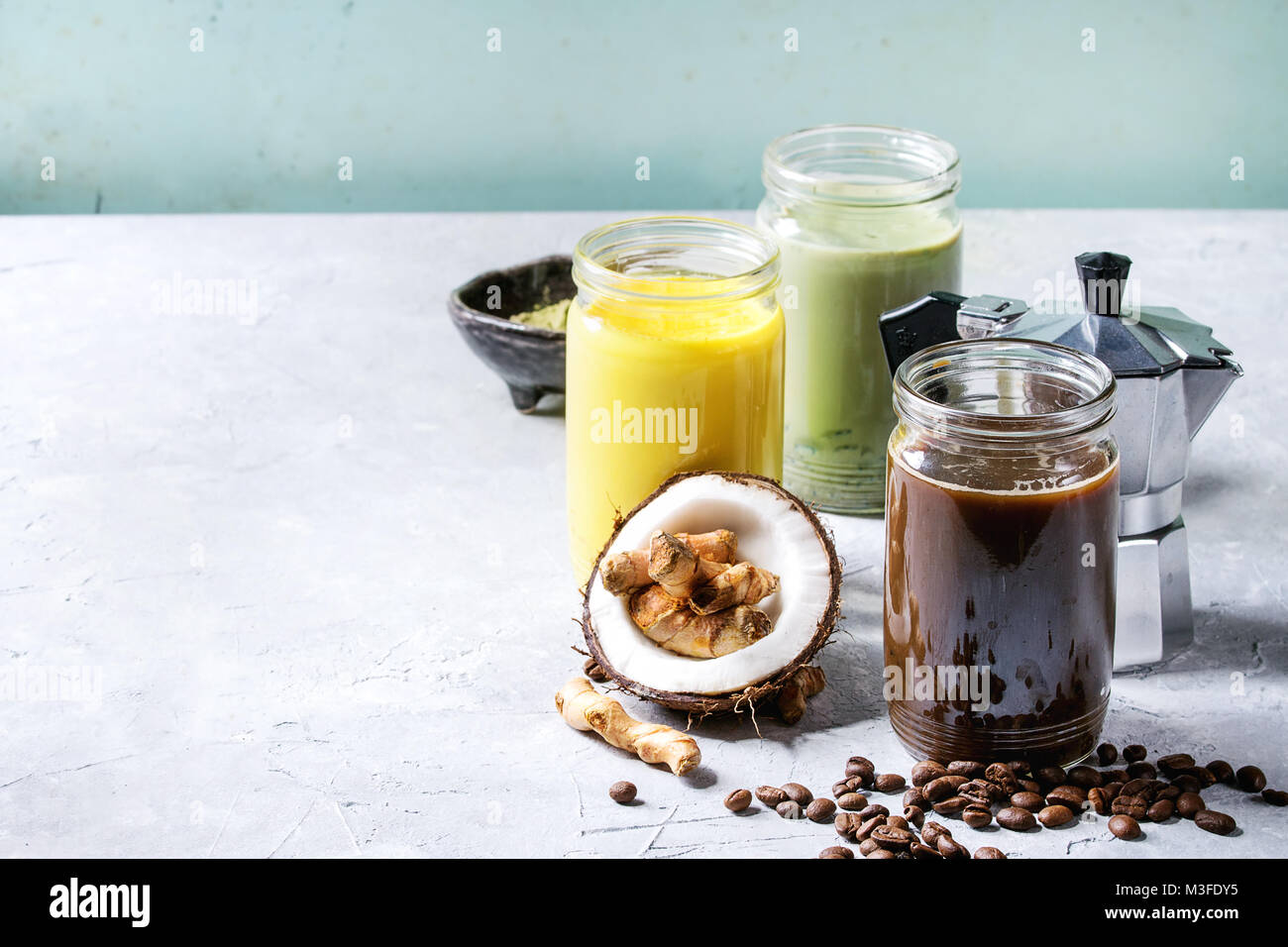 Variety of iced colorful latte drinks. Iced coffee, turmeric and matcha ...