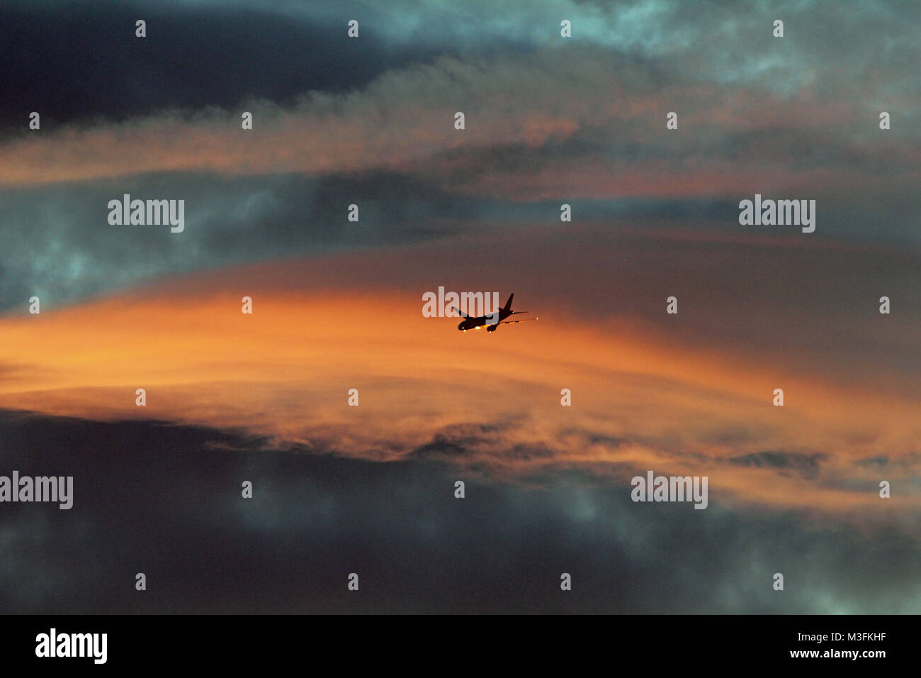 Plane with clouds hi-res stock photography and images - Alamy