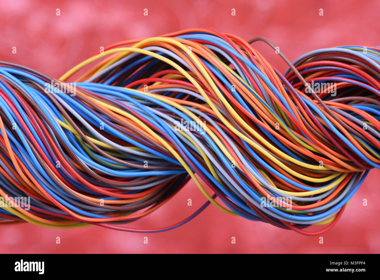 Multicolored electrical cable on red background Stock Photo - Alamy