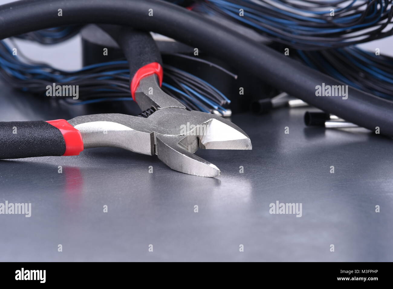 Electrician tools on metal board Stock Photo - Alamy