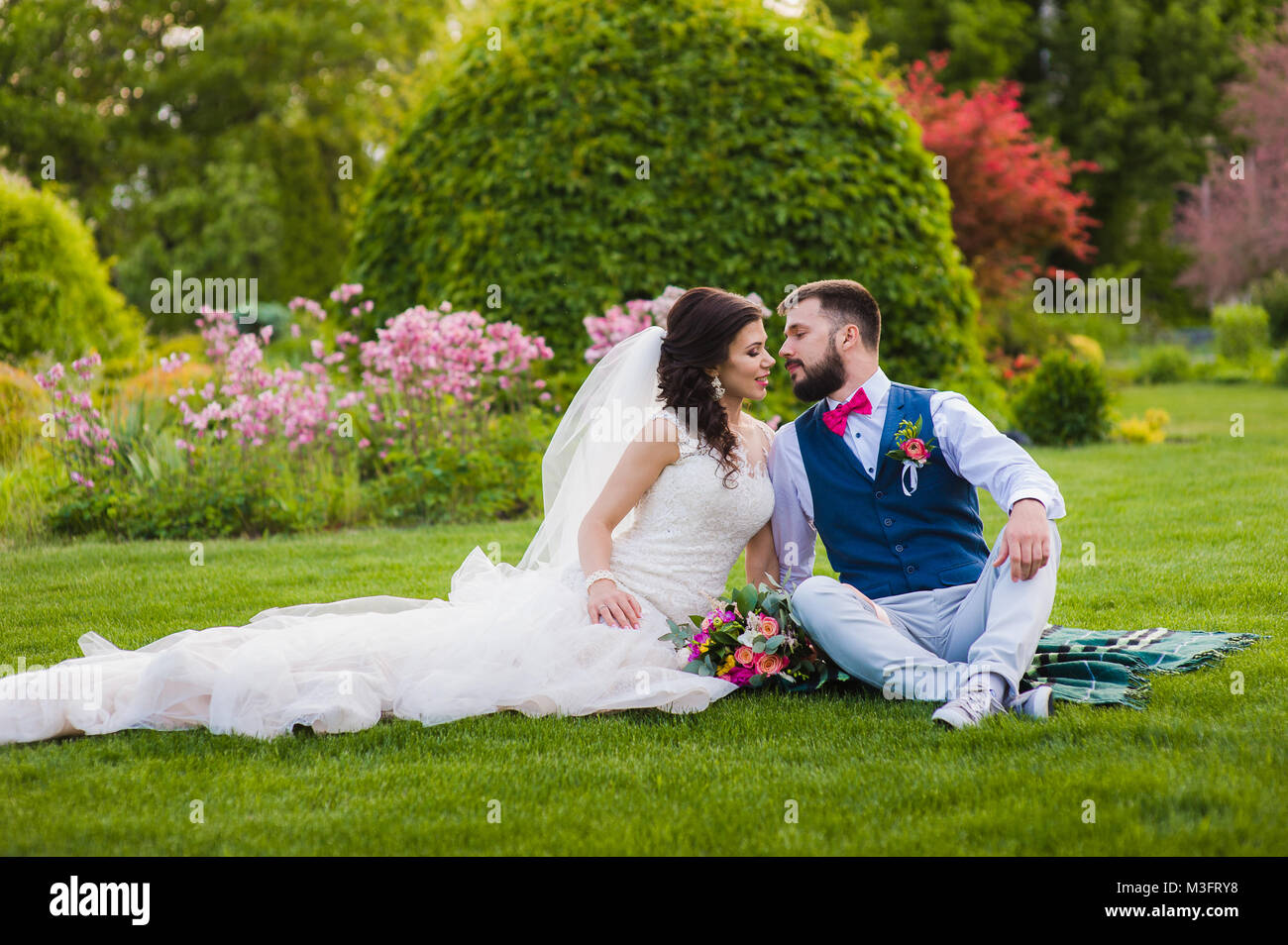 Bride and groom showing their feelings during wedding day outdoors ...