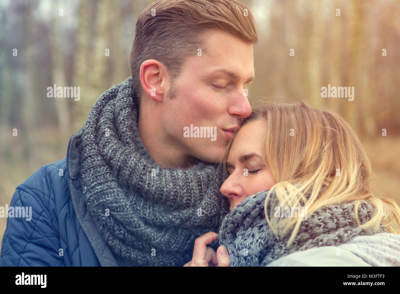 portrait of couple outdoors in the cold hugging each other Stock Photo ...
