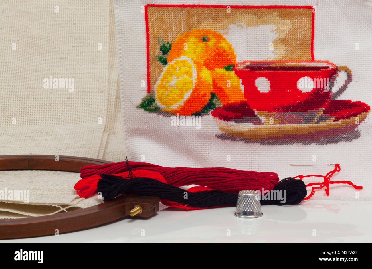 needlework set of threads embroidery frame on a background of finished ...