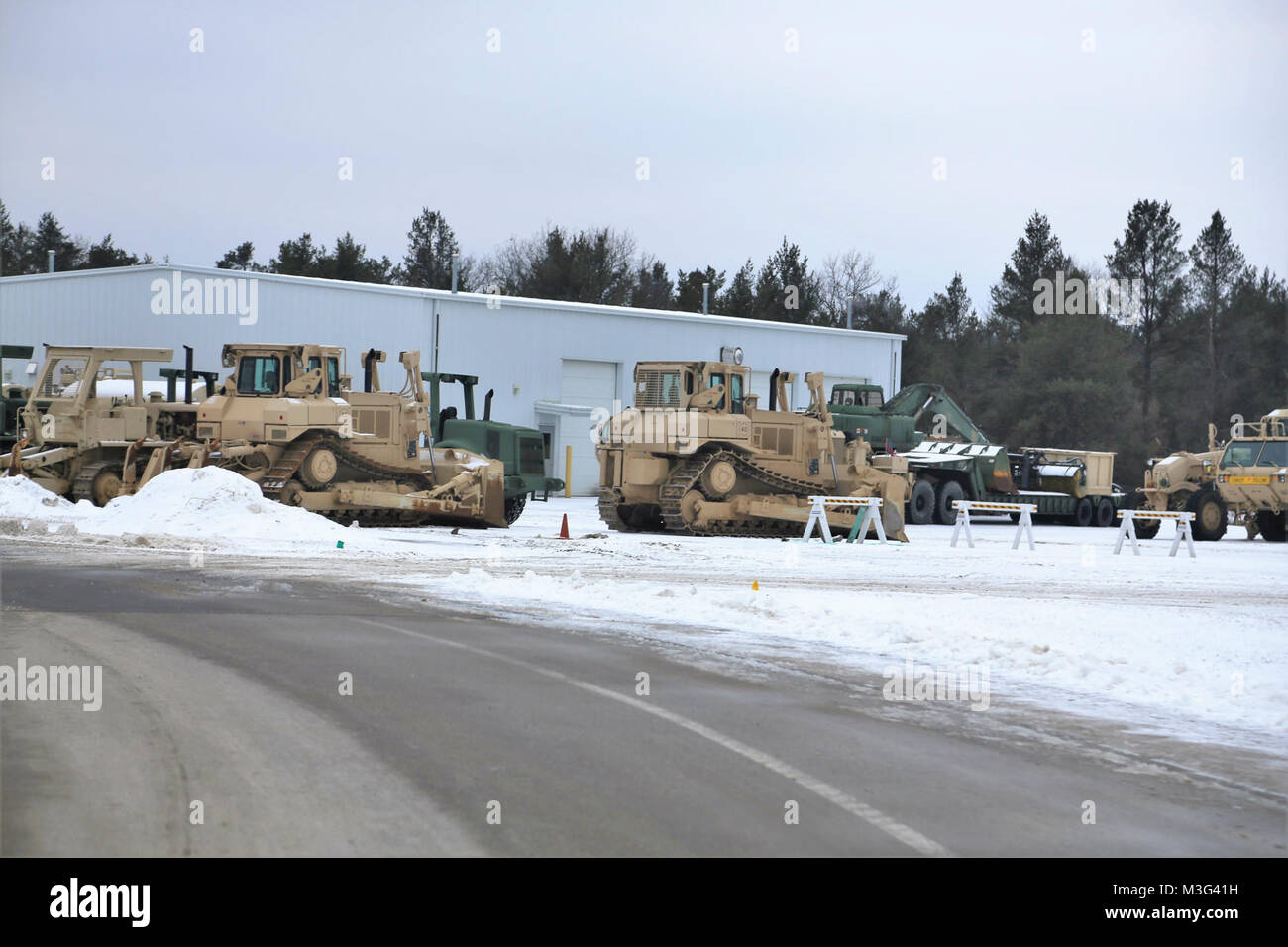 Army military vehicles are parked at a staging area Jan. 24, 2018, on ...