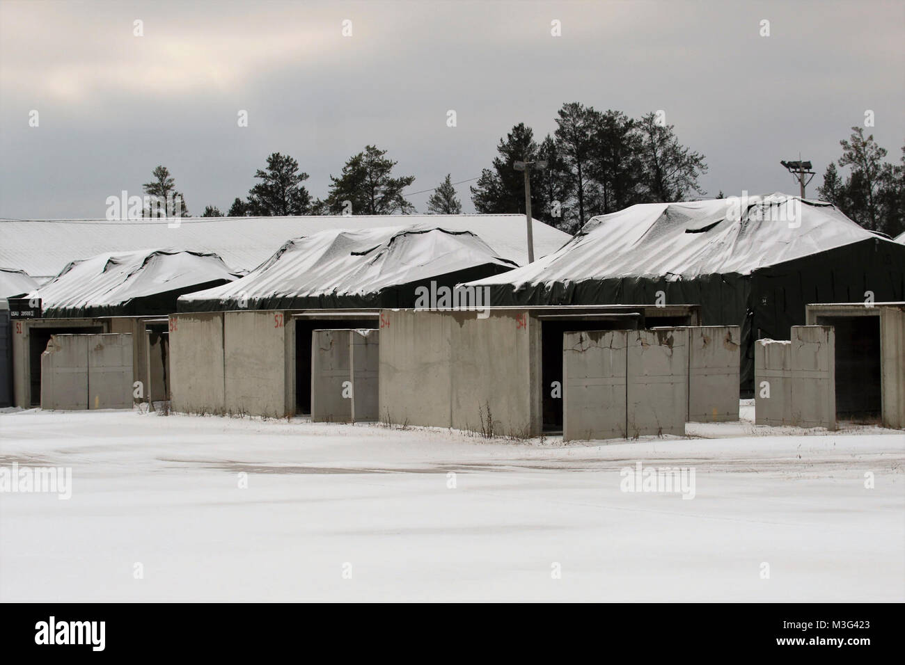 Tents are shown covered in snow at Improved Tactical Training Base ...