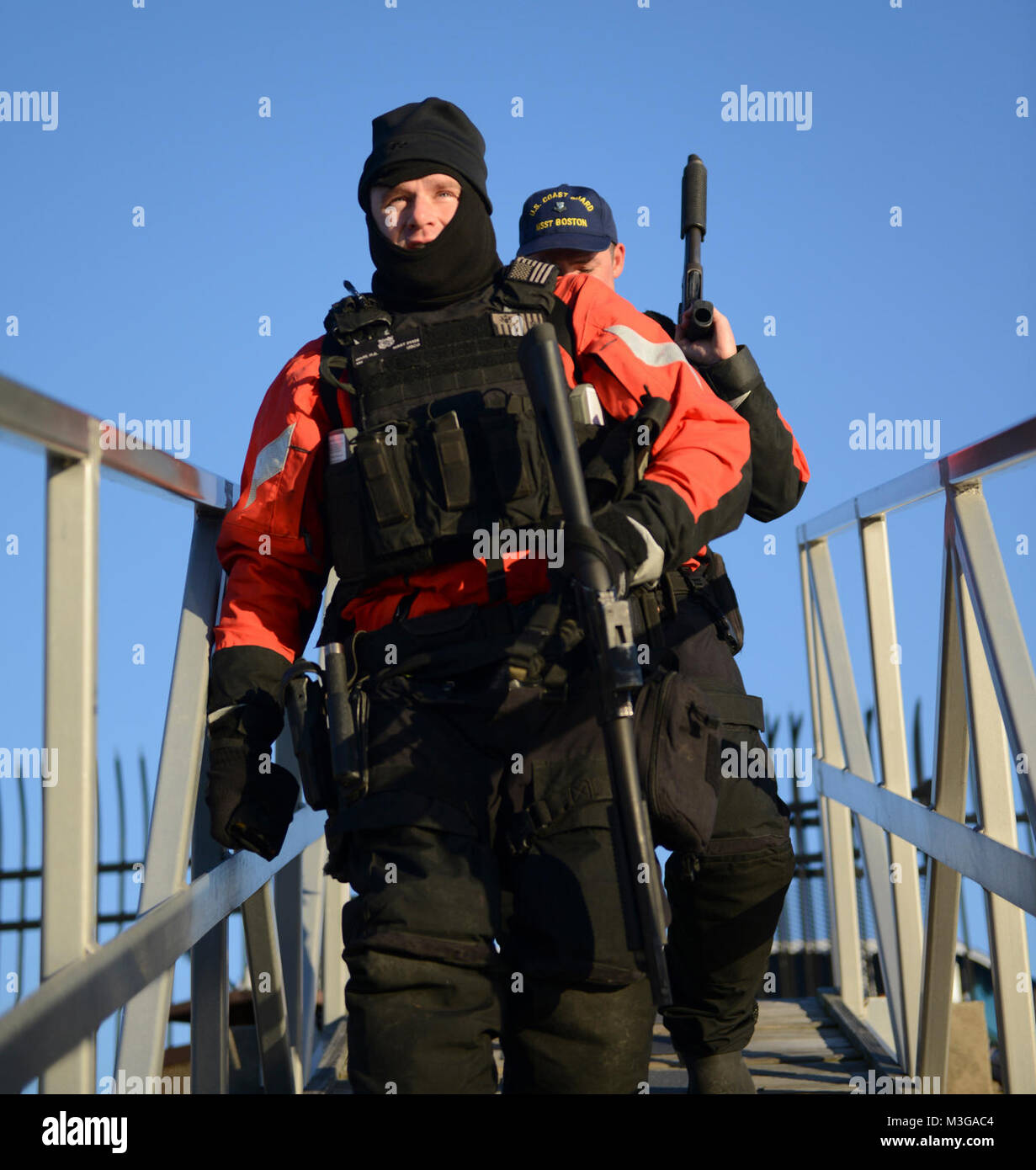 Coast Guard Maritime Safety and Security Team members walk down the ...