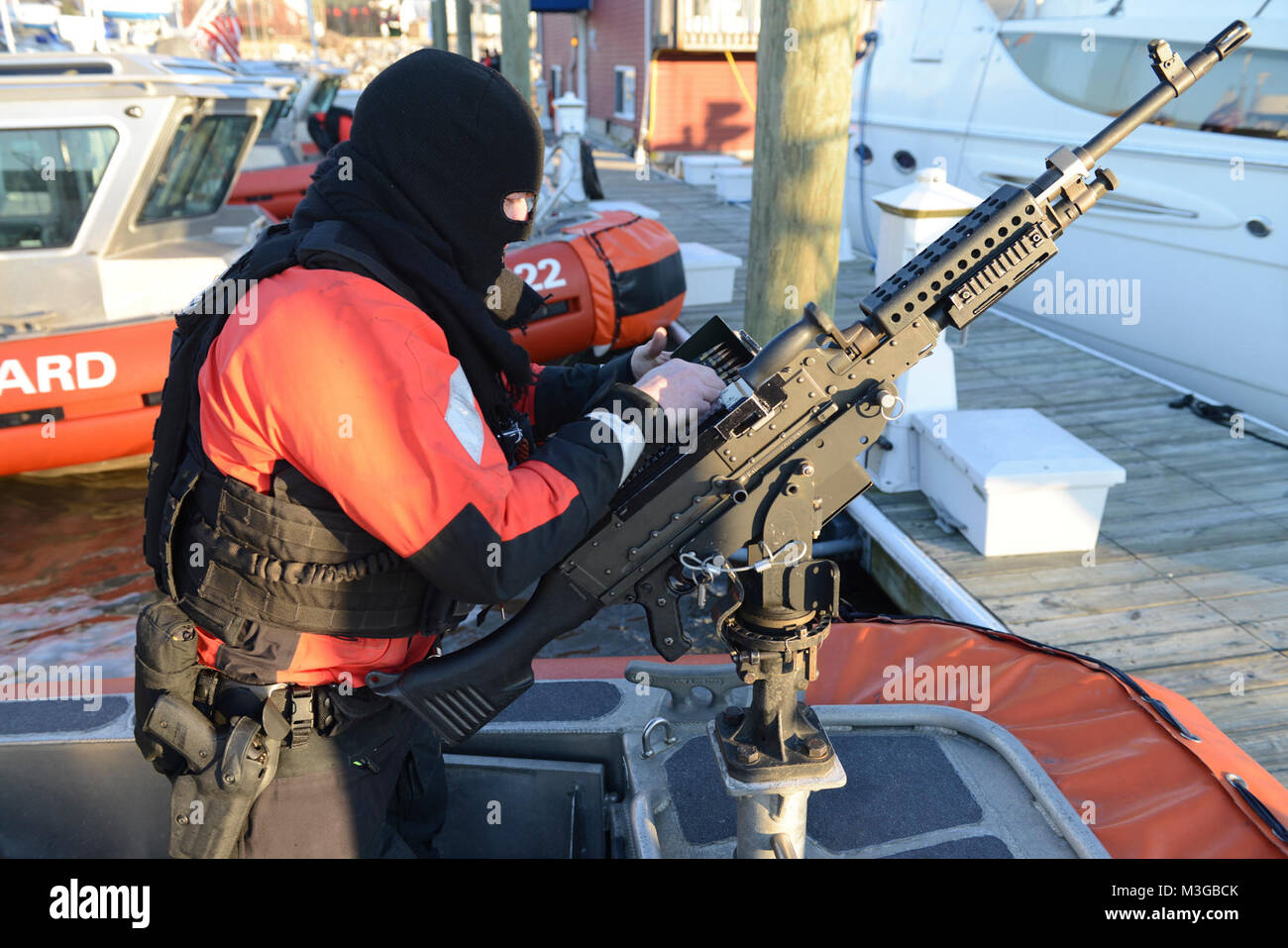 A Coast Guard Maritime Safety and Security Team member readies the ...