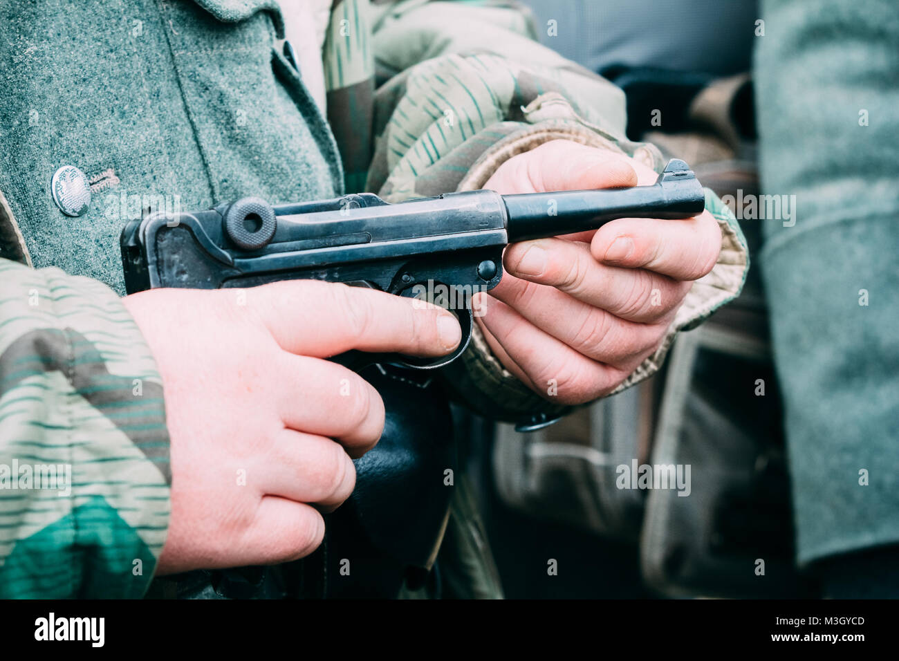 The Parabellum pistol in the hands of a German soldier, World War II ...