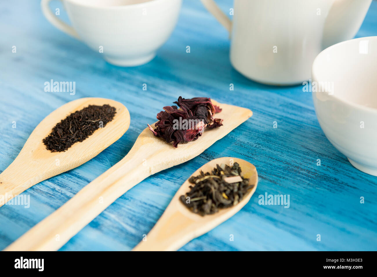 Three wooden spoons with tea leaves Stock Photo - Alamy